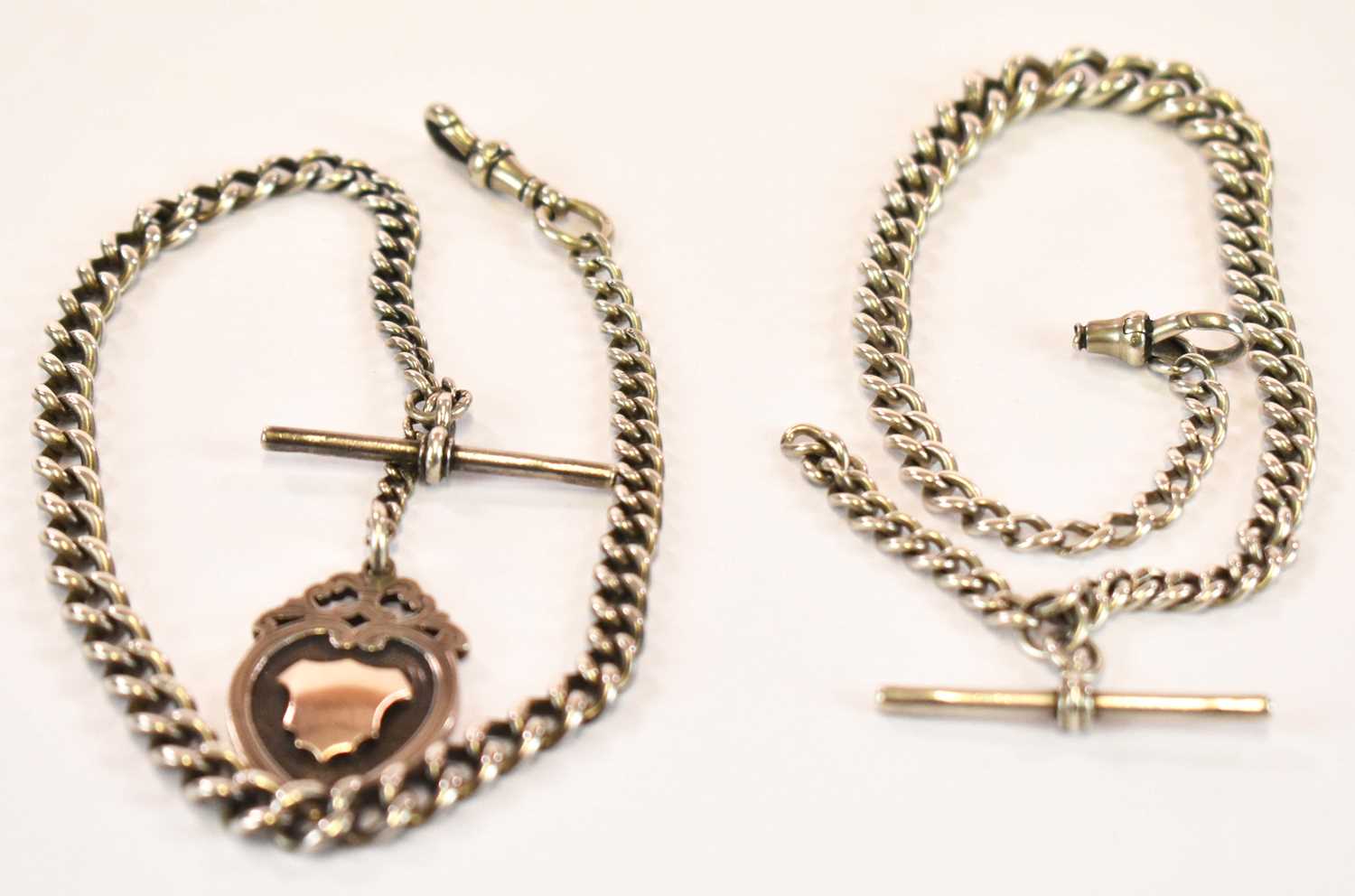 Lot 1303 - Two hallmarked silver Albert chains and a