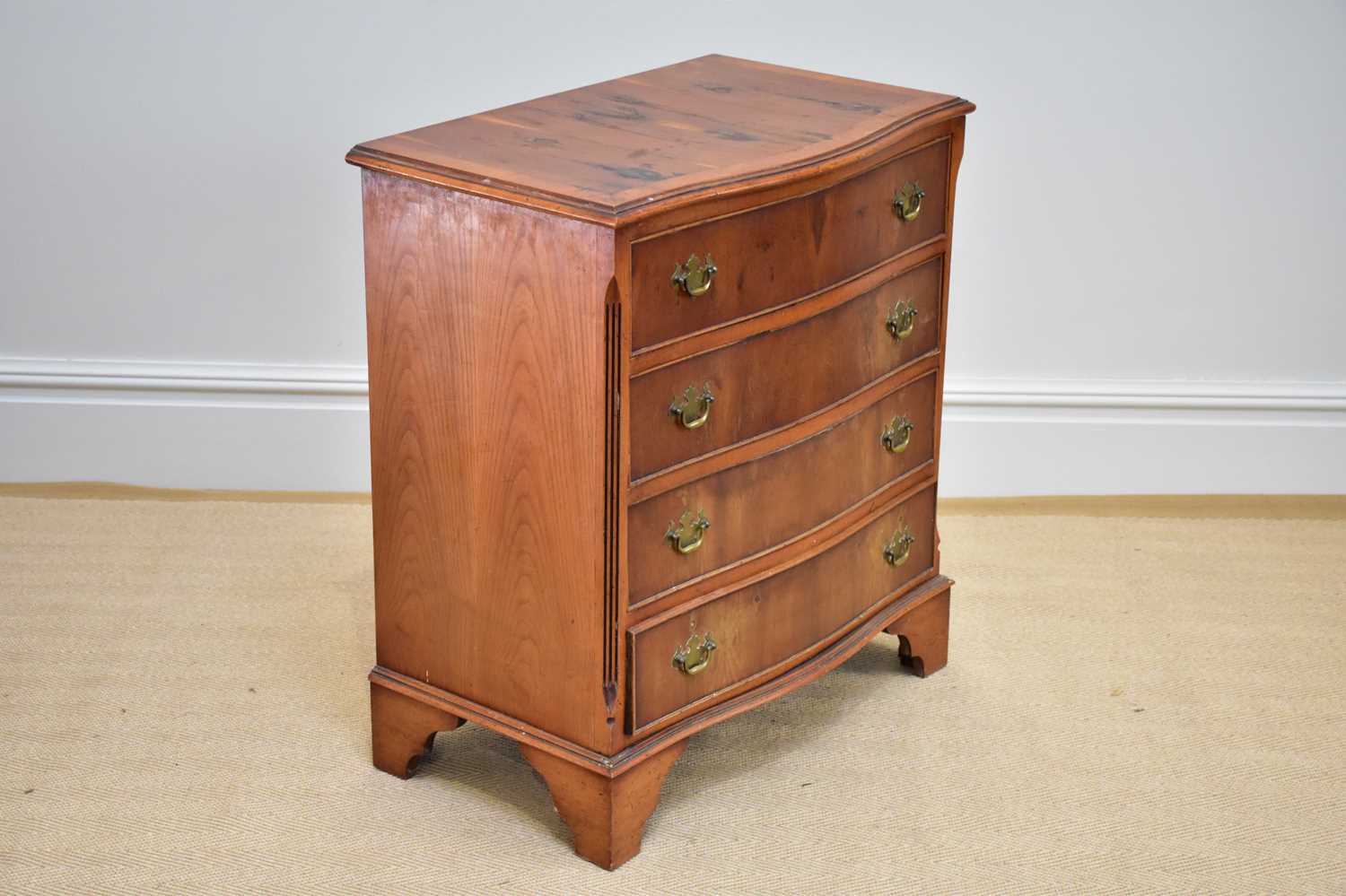 Lot 1137 - A reproduction serpentine fronted yew wood