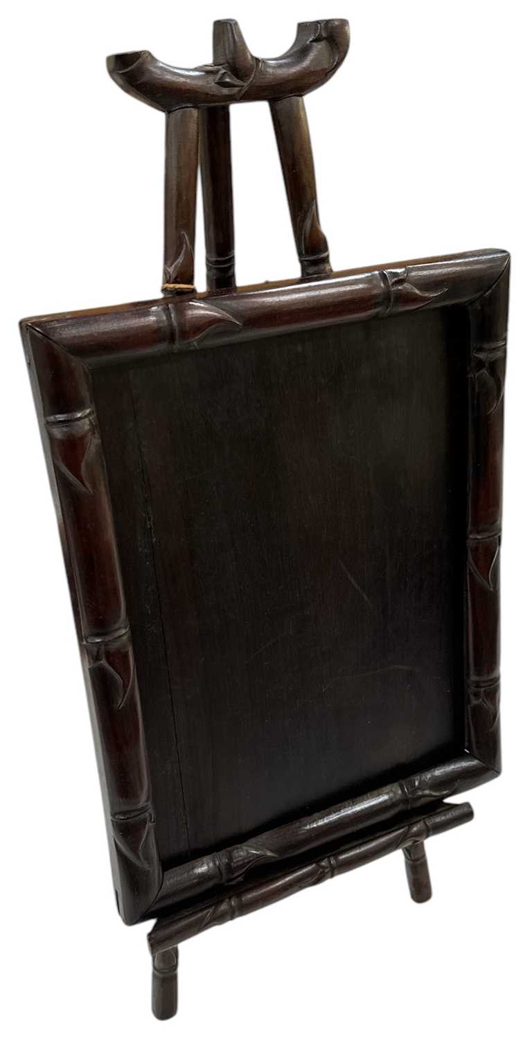 Lot 1007 - A Chinese carved hardwood easel, with a