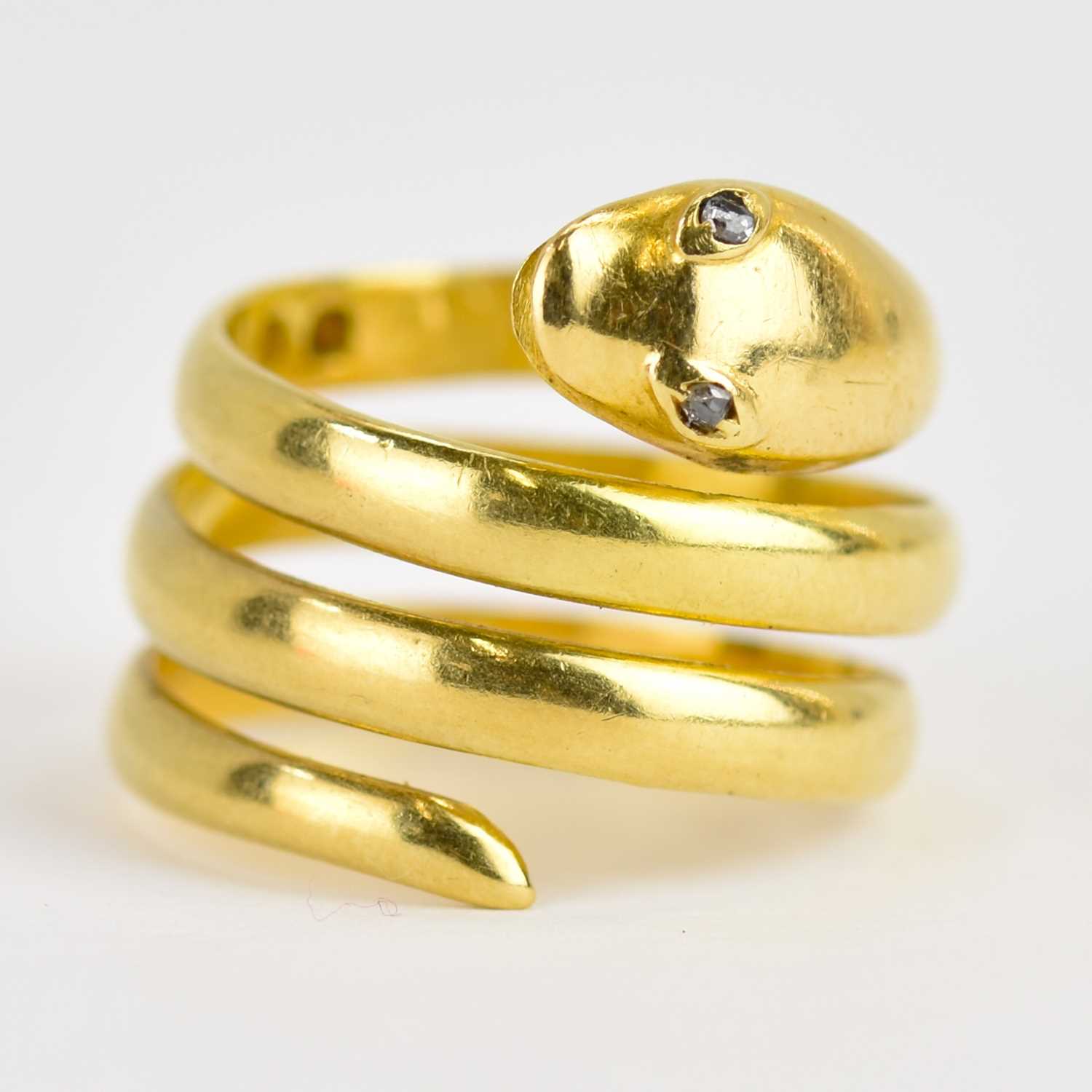 Lot 958 - An 18ct yellow gold coiled snake ring, set
