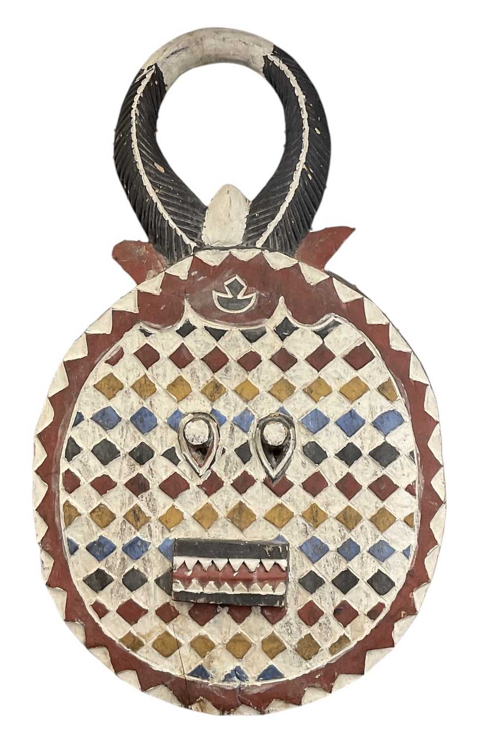 Lot 1217 - A large African Baule mask with red, white,