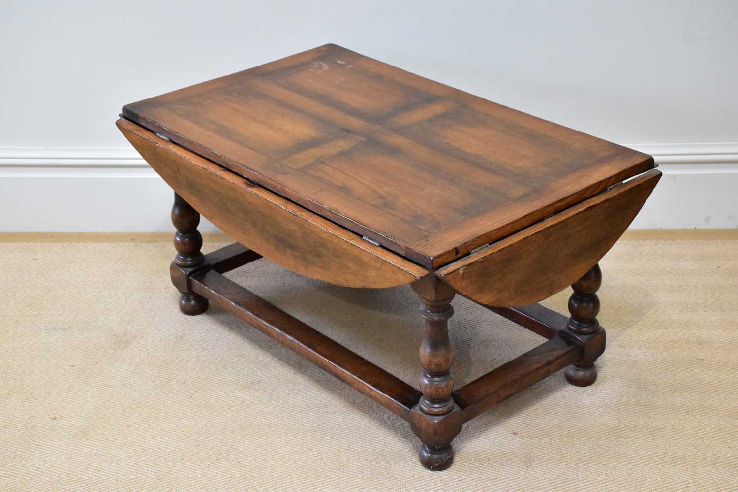 Lot 250 - A reproduction oak drop-leaf coffee table,