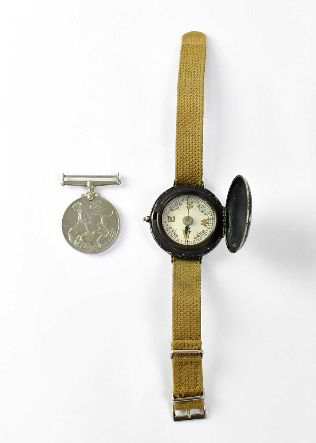 Lot 582 - A military wrist compass on a webbing strap