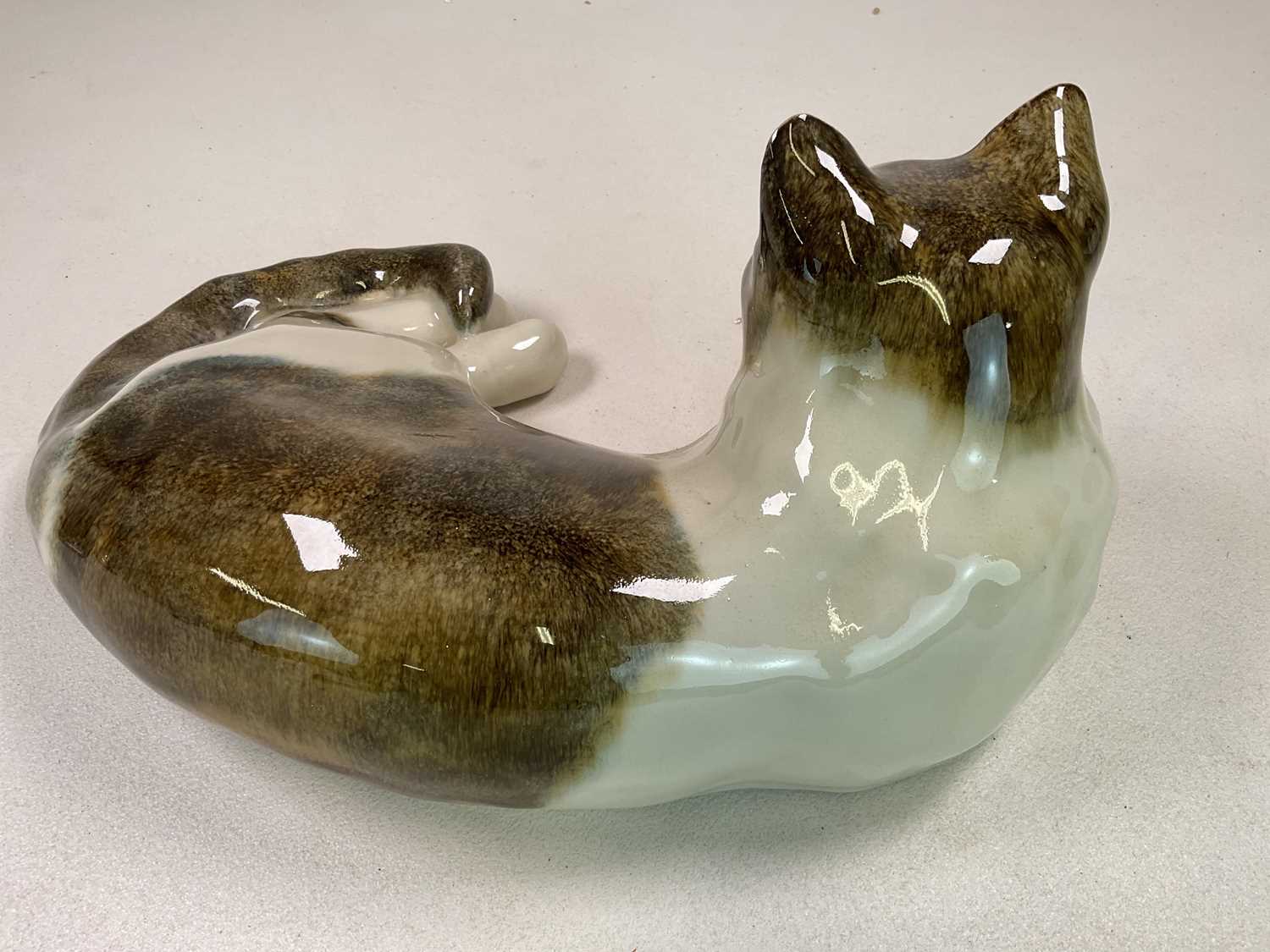 Lot 268 - WINSTANLEY; a cat in recumbent position,