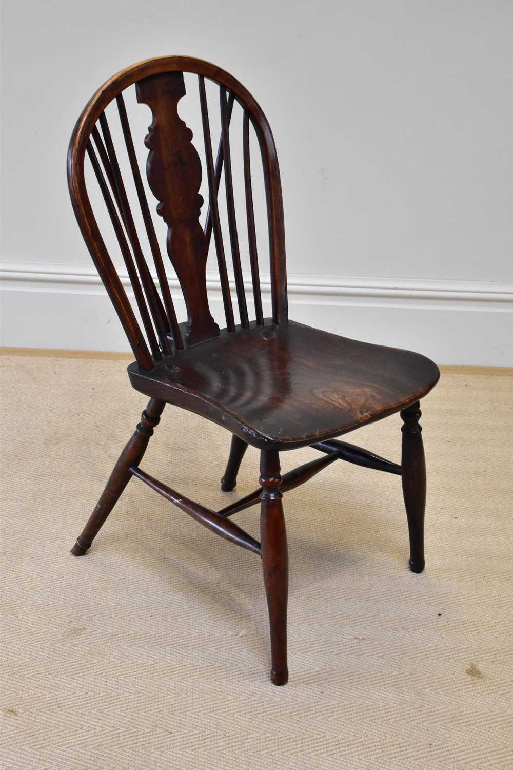 Lot 179 - A 19th century elm seated Windsor type chair,
