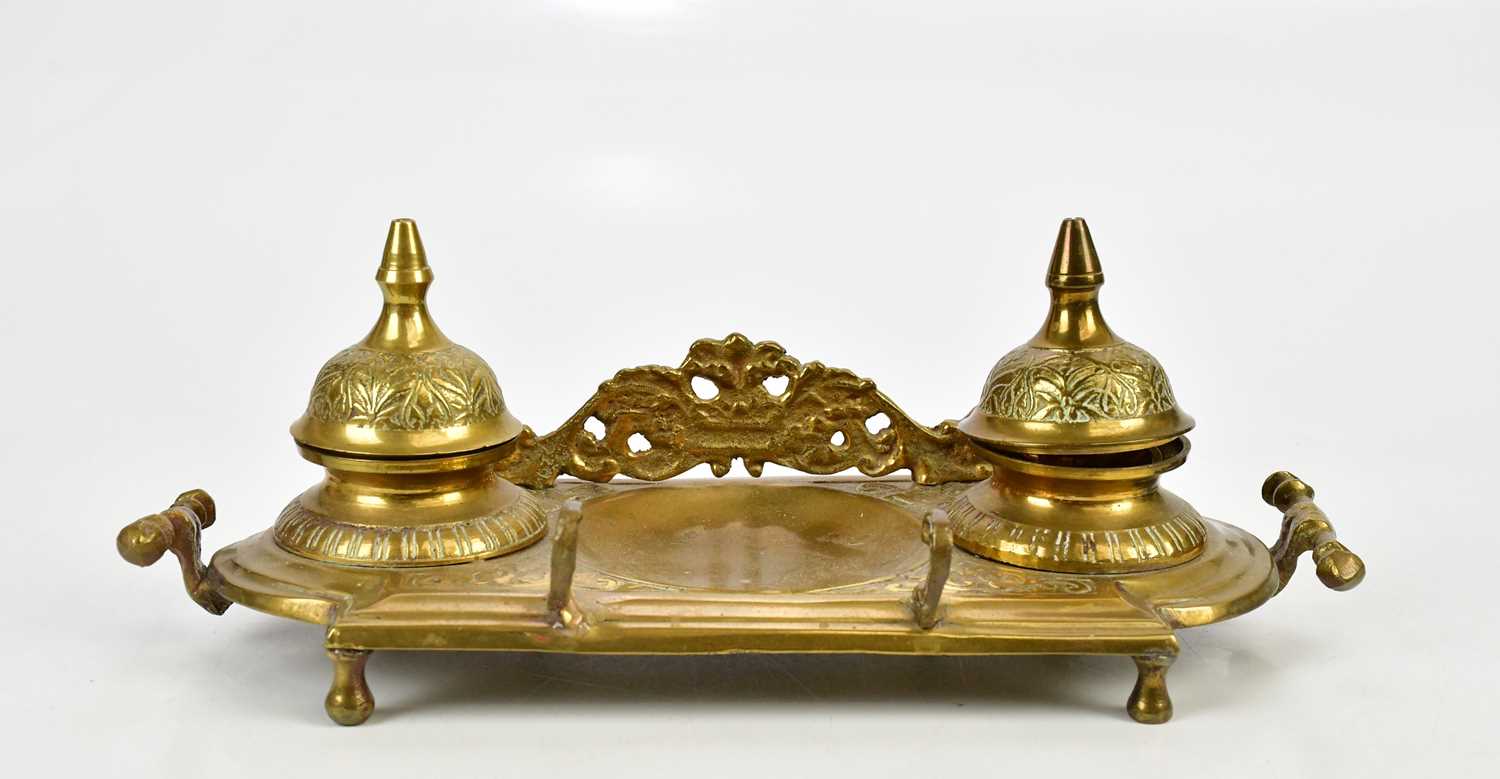 Lot 1613 - A brass ink stand with two covered inkwells,