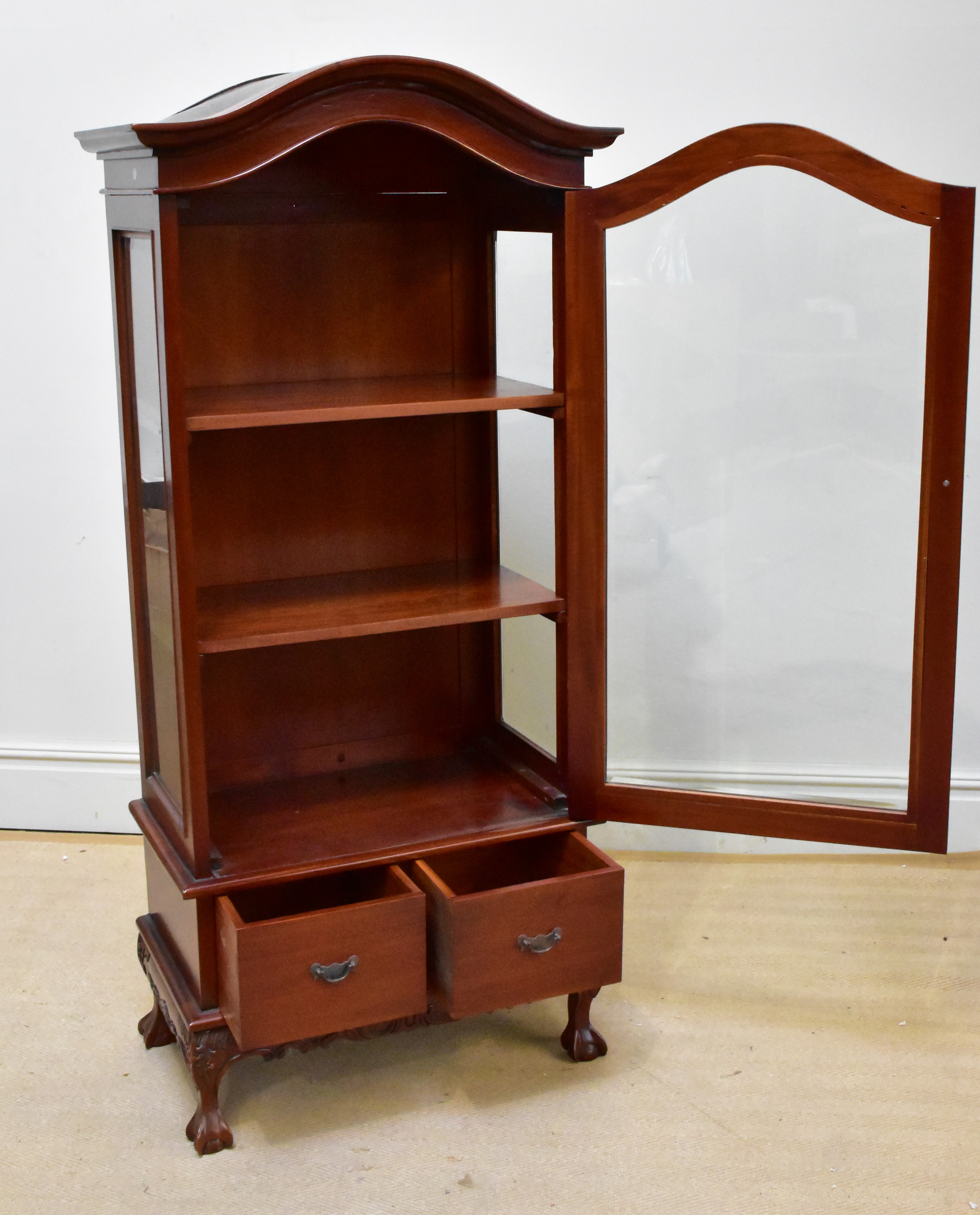Lot 1062 - A reproduction display cabinet with arched