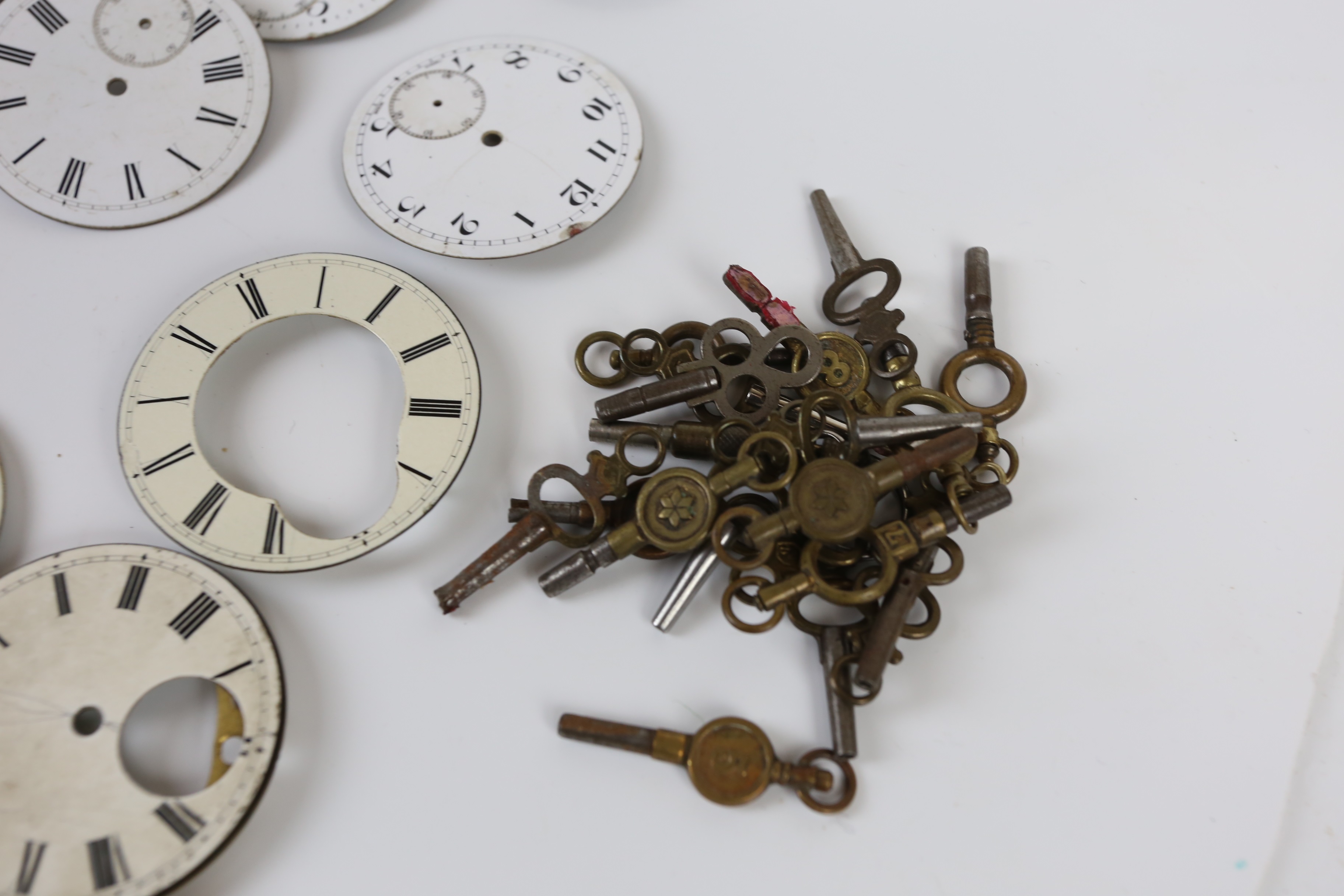 Lot 688 - A collection of various pocket watch faces,