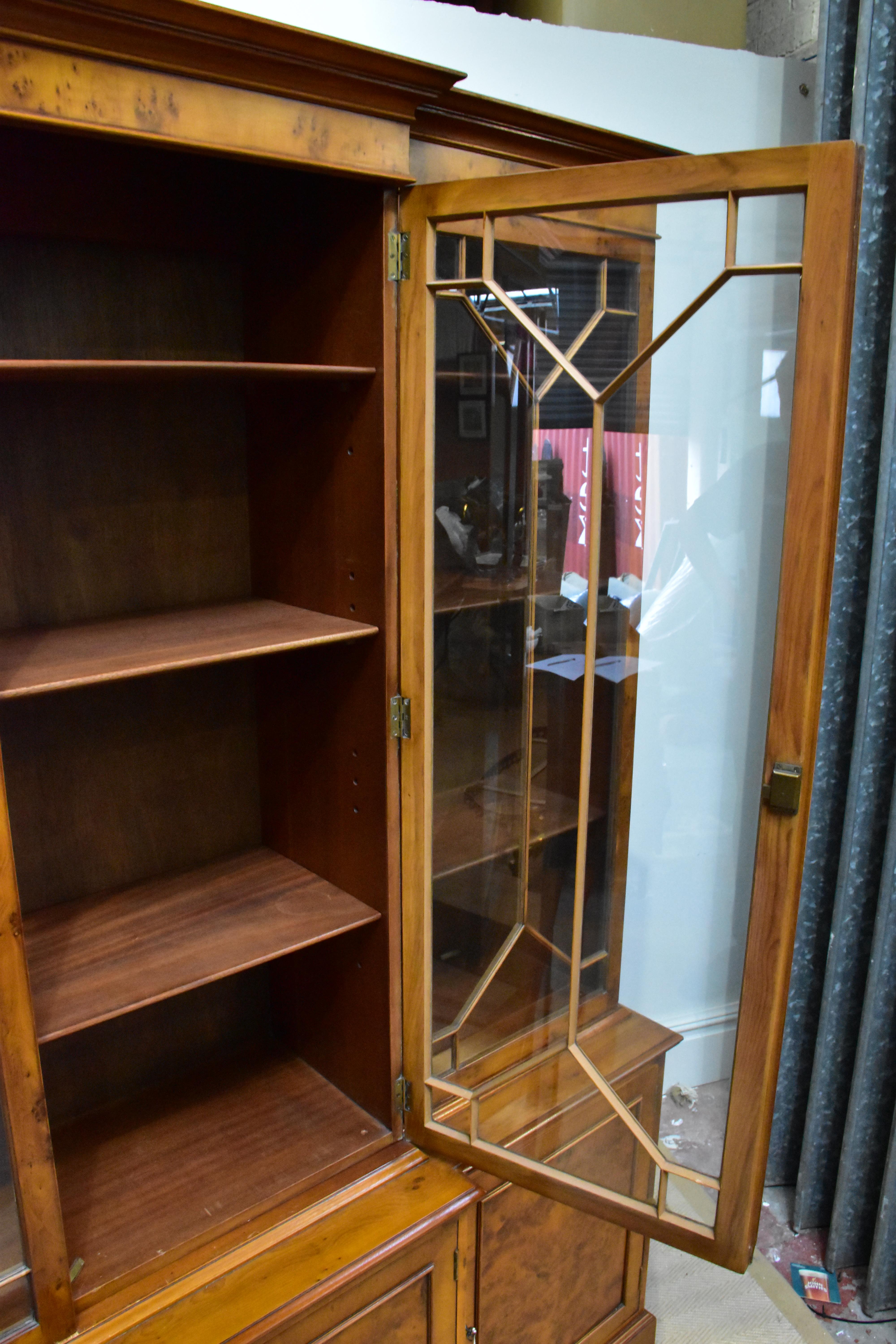 Lot 1171 - A reproduction yew wood breakfront display