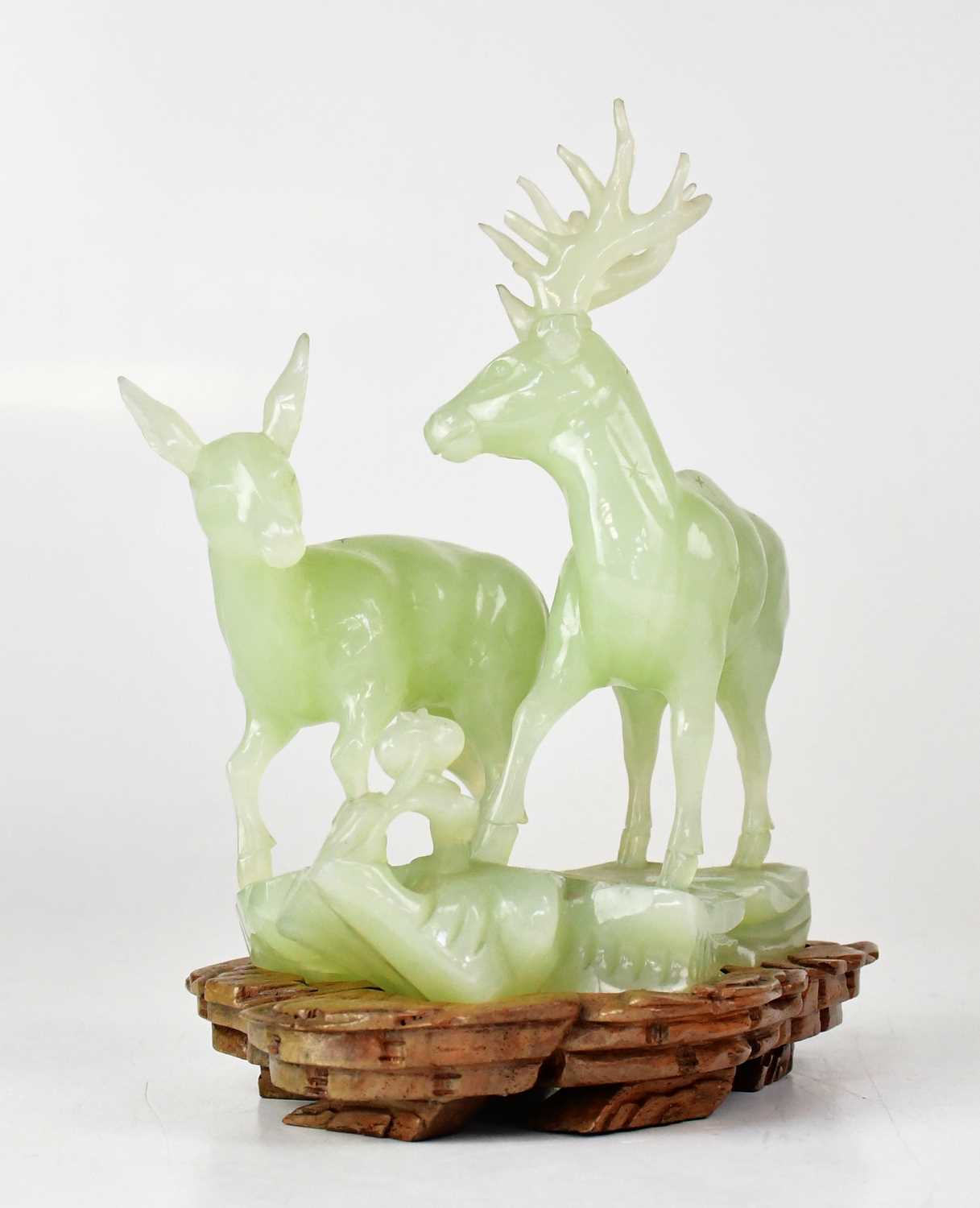 Lot 323 - A green jade figure group of a stag and doe,