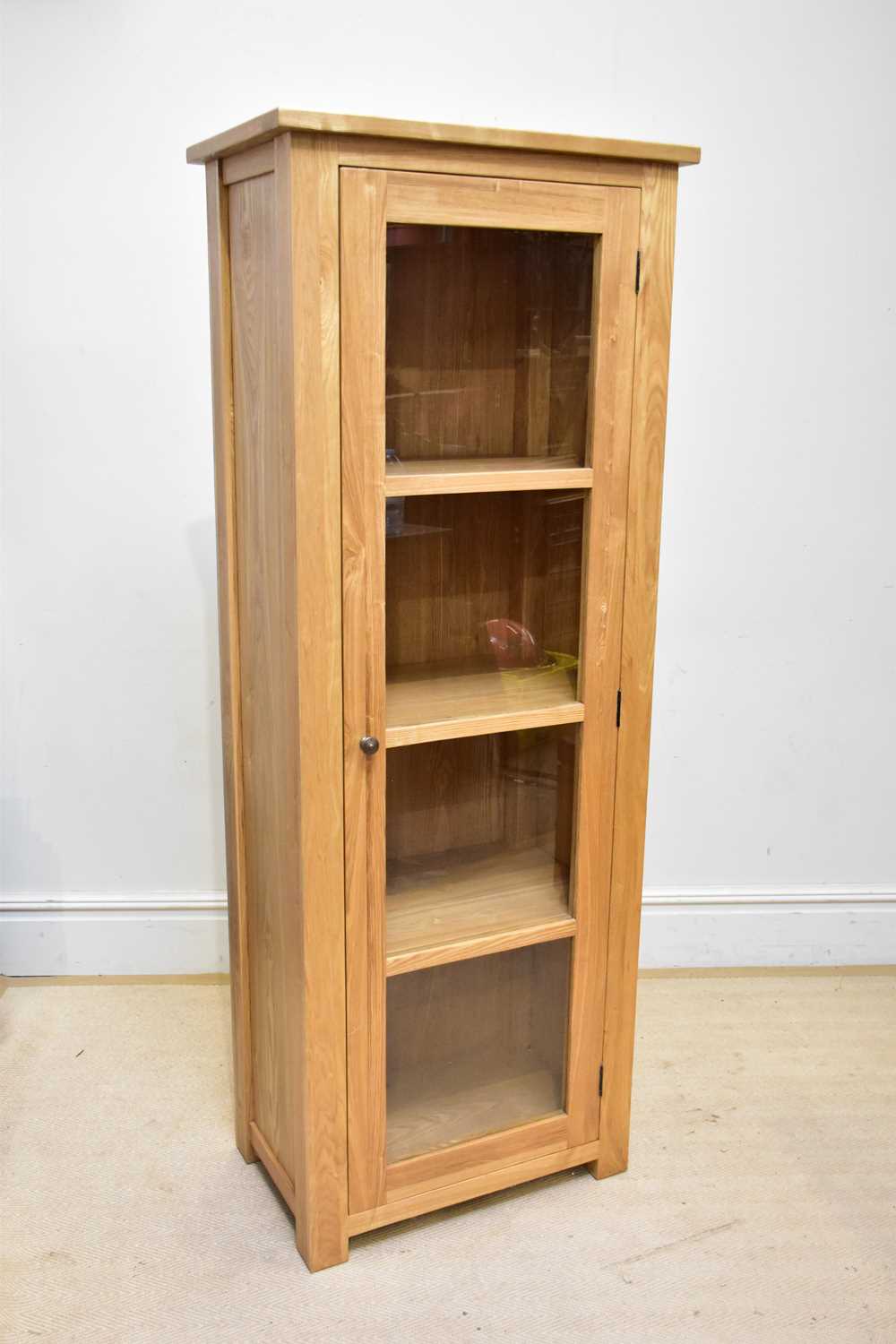 Lot 53 - A modern light oak display cabinet, with