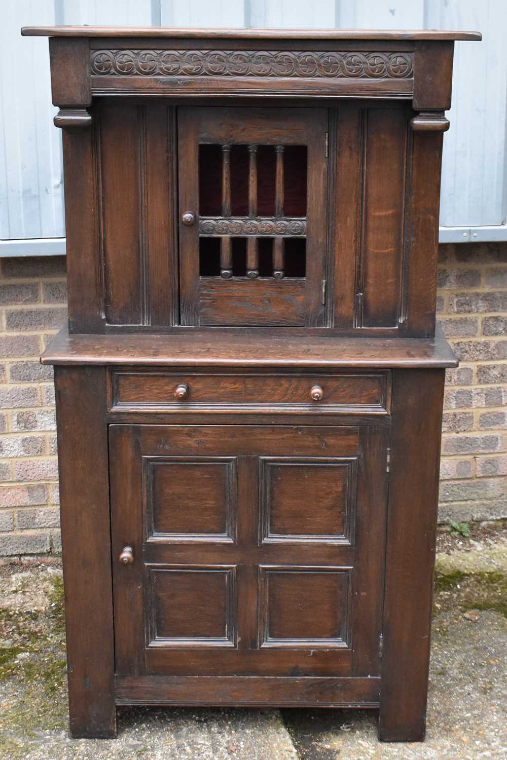 Lot 101 - A reproduction oak court cupboard with