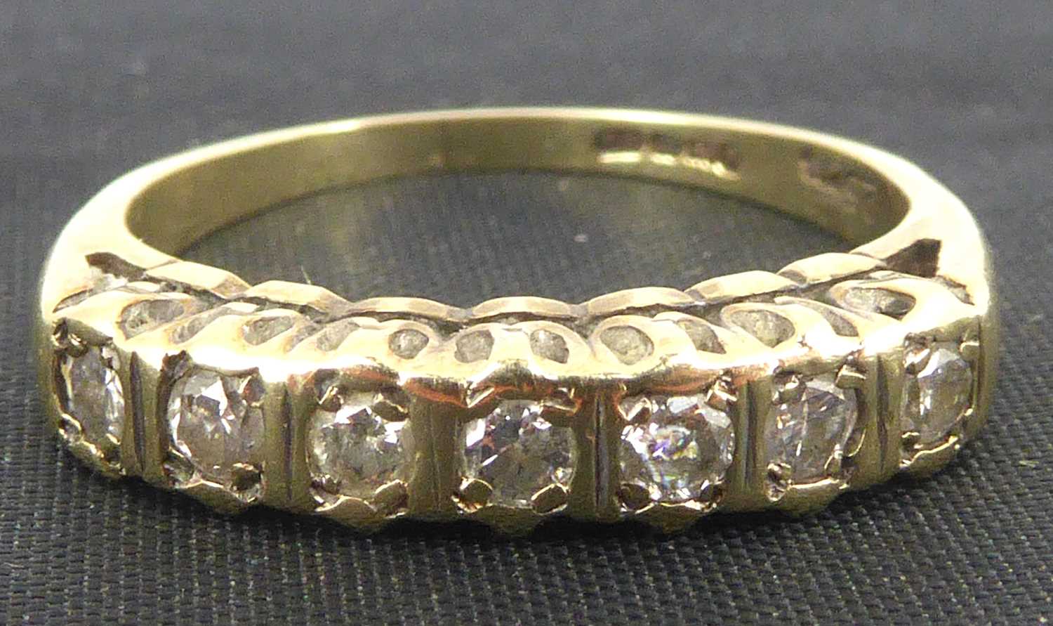Lot 758 - A 9ct gold seven-stone diamond ring, the