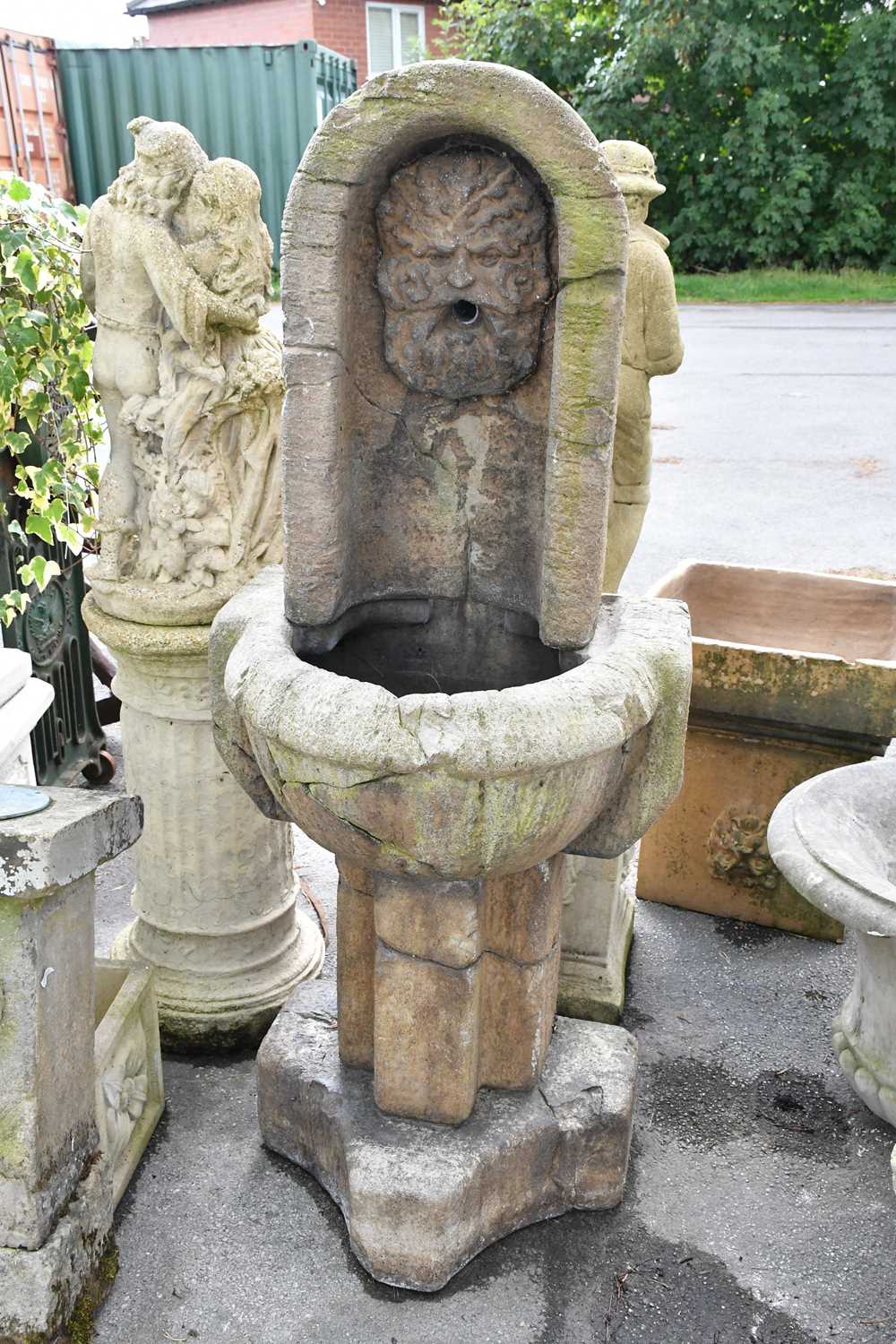 Lot 251 - A large stone garden font with mask head