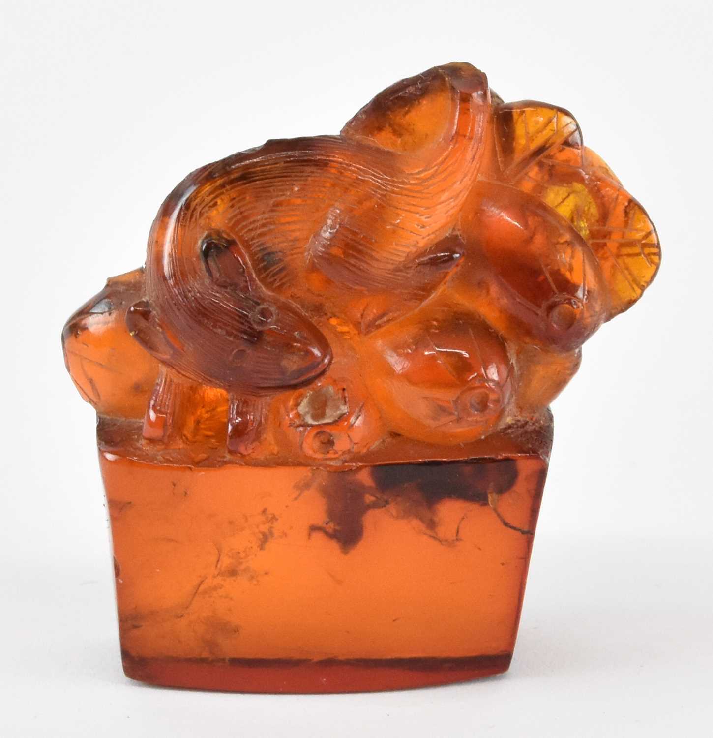 Lot 279 - A small figural amber/amber type seal, with