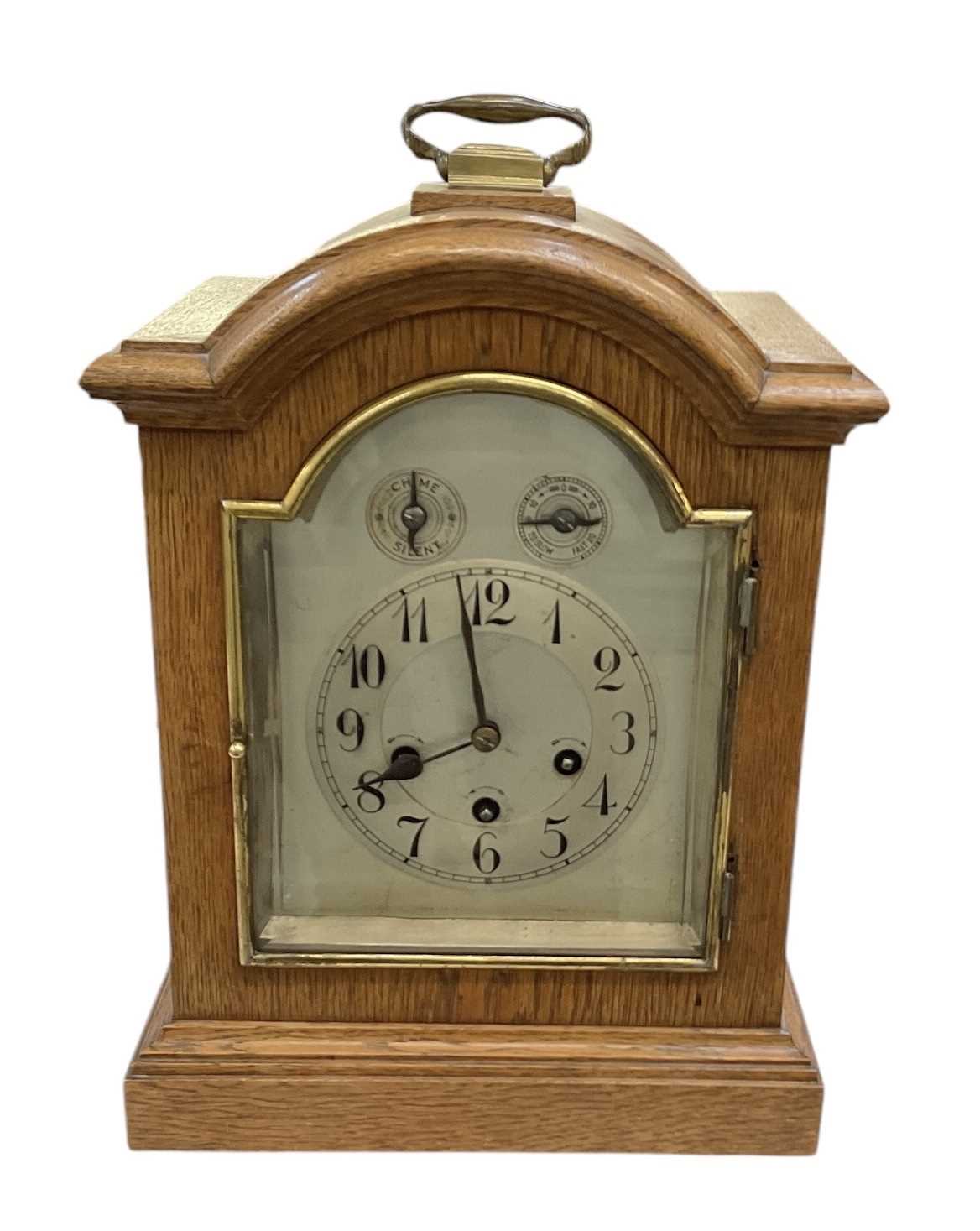 Lot 97 - An early 20th century oak cased mantel clock