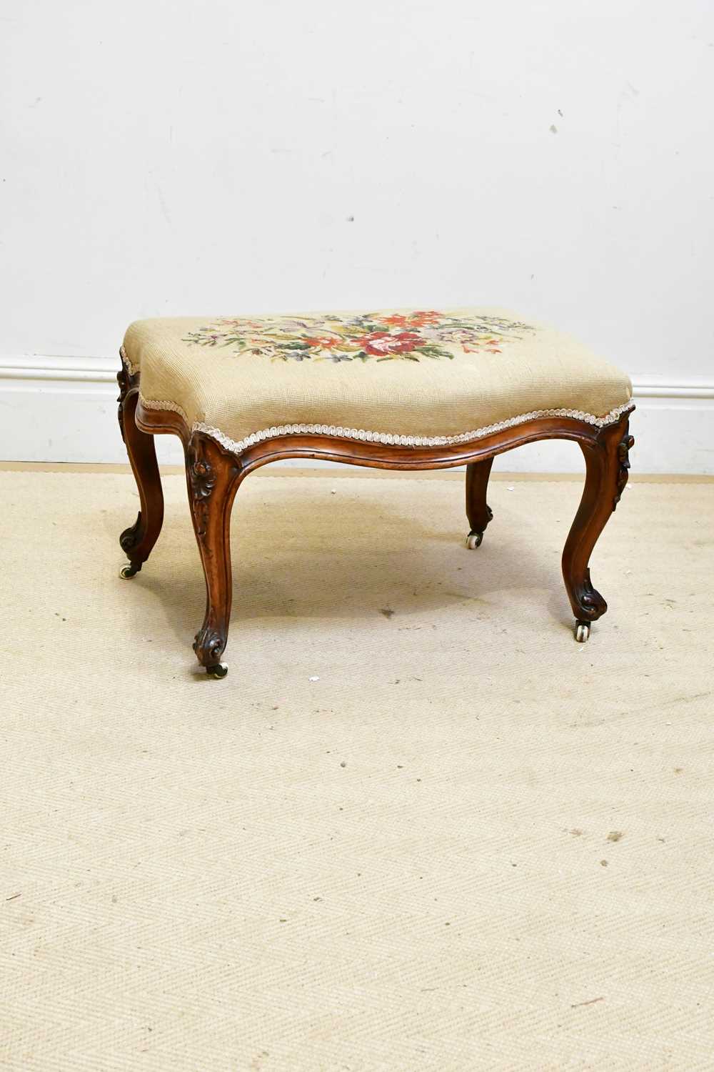 Lot 150 - A Victorian carved walnut serpentine stool,
