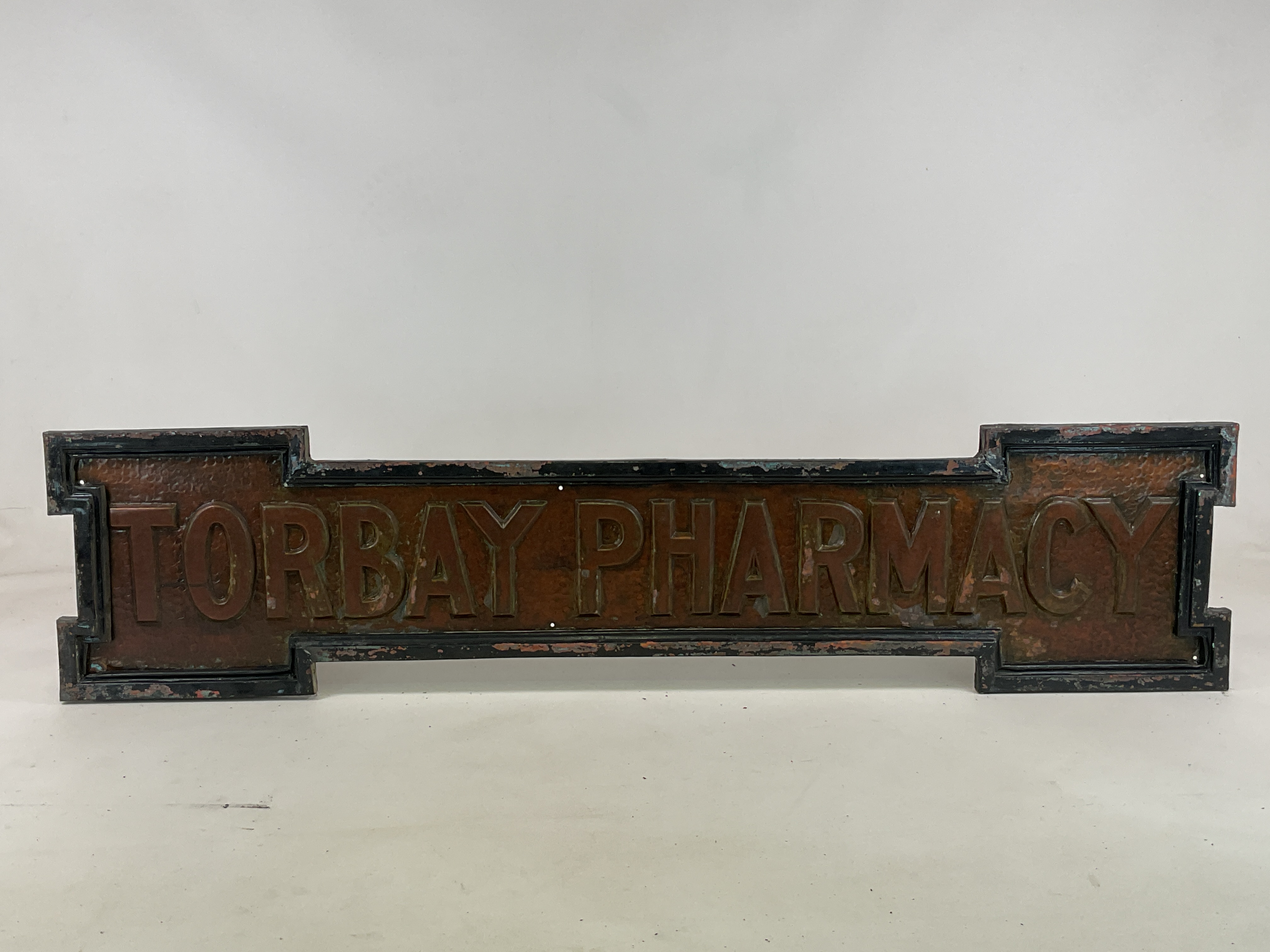 Lot 3 - TORBAY PHARMACY; a hammered copper shop front